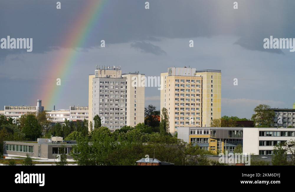 A rainbow in a urban housing space with tall buildings in a city in ...
