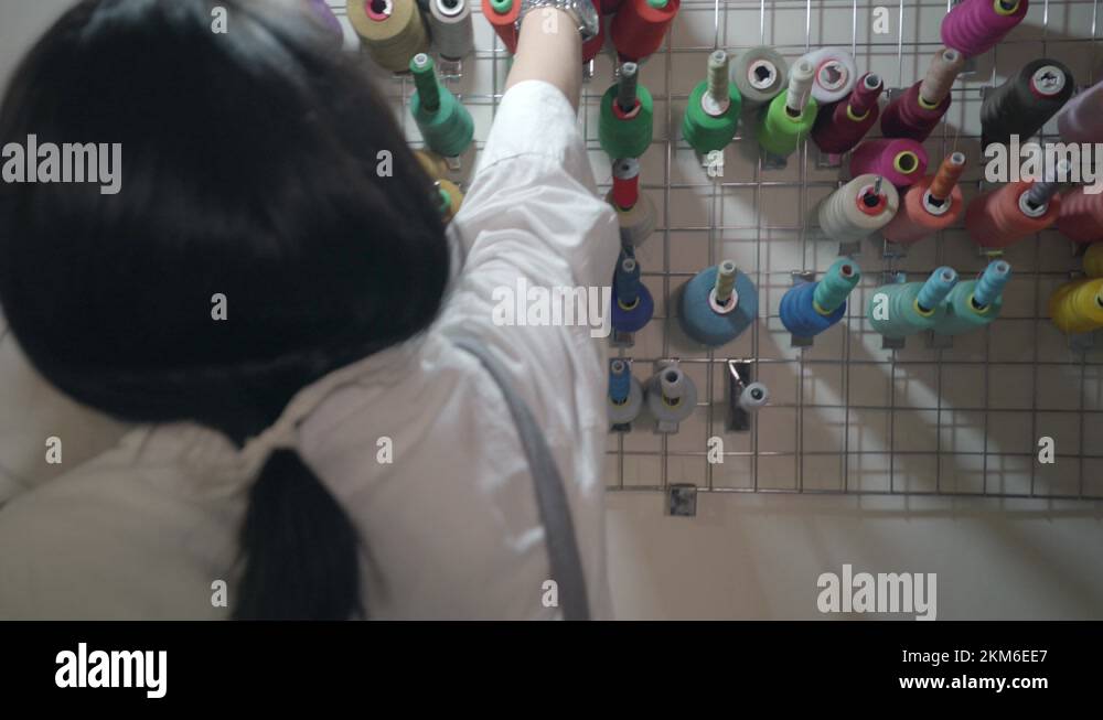 Rows spools of thread of different colors in the industrial sewing ...