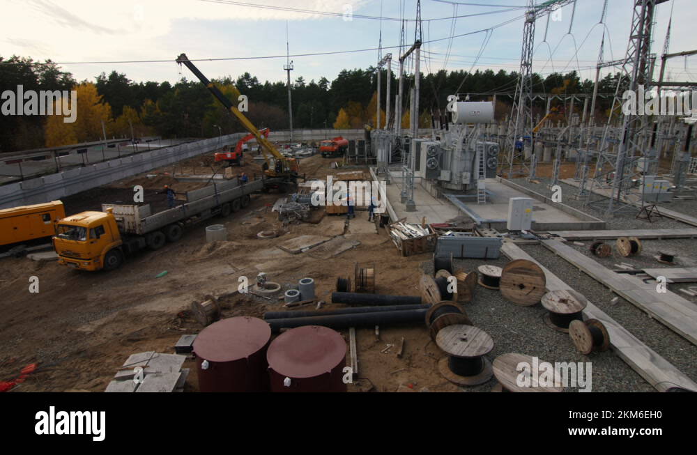 Men walk along construction site of electrical substation Stock Video ...