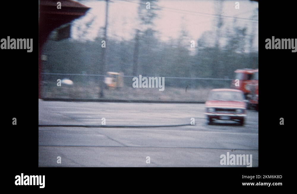 1970s Canada: Tour bus sits in parking lot near small Canadian airport ...