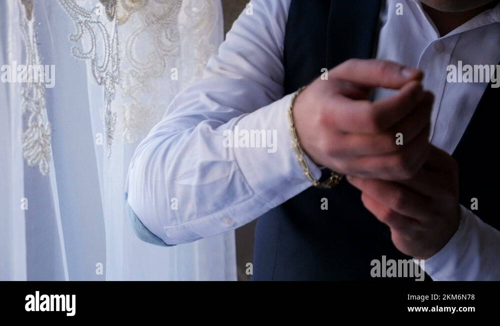 A close up business man puts into the hands of the clock slow motion ...