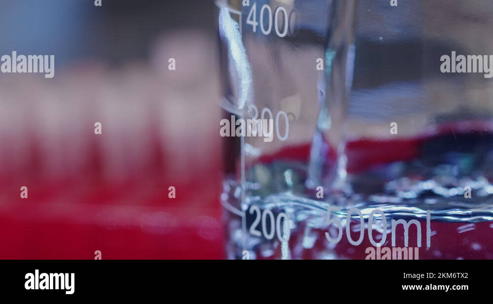 Pouring water into glass flask with scale in laboratory Stock Video ...