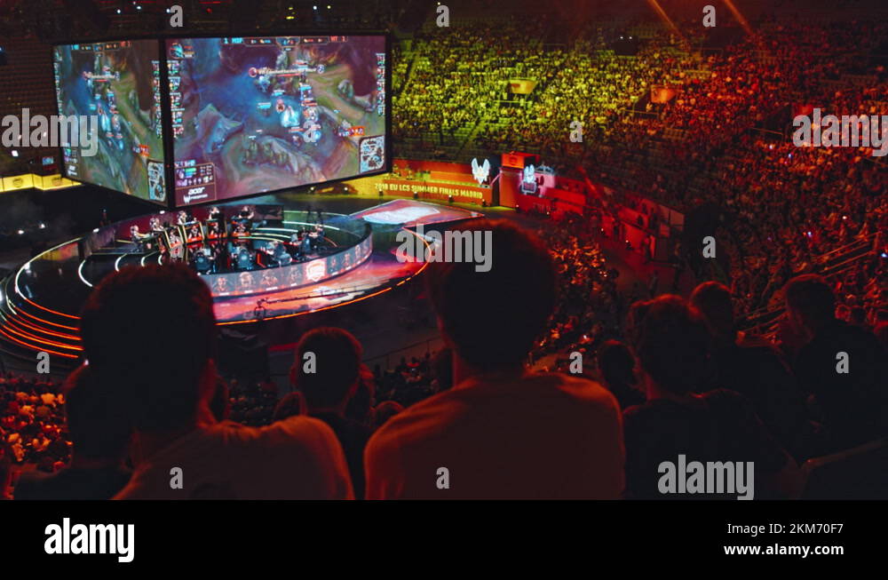 Crowded stadium. League of Legends match. Gameplay on a giant display ...