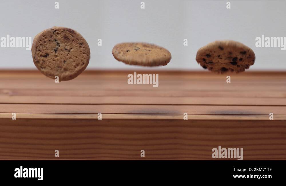 Three Chocolate Chip Cookie Spinning and Rolling in the Air above ...