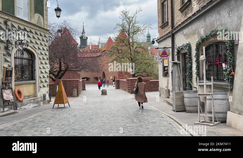 Walking through one of the main paved streets in Warsaw Old Town area ...