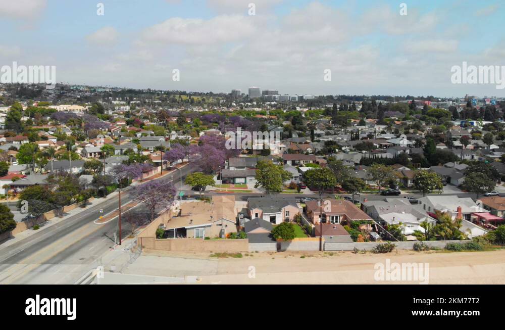 Aerial sideways fly over Los Angeles river looking over a neighborhood ...