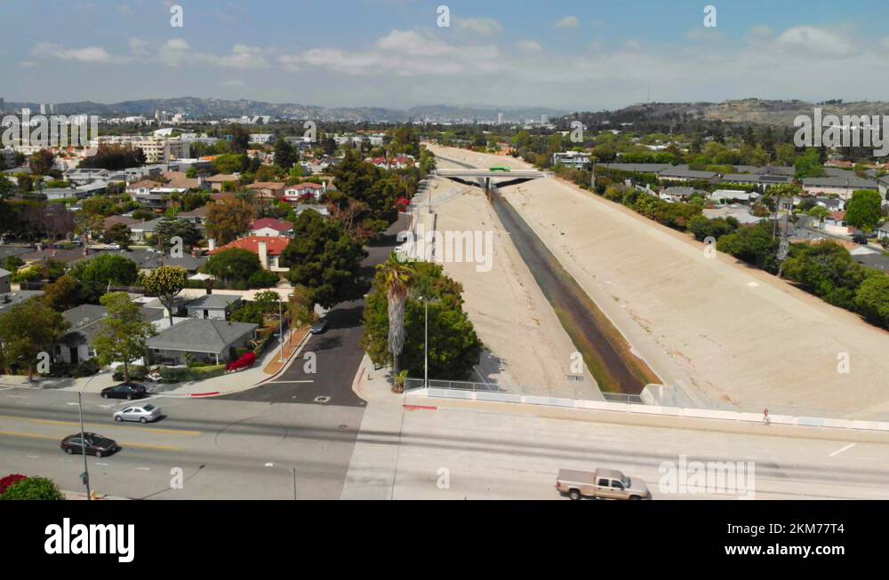 Aerial fly over Los Angeles neighborhood street with local traffic ...
