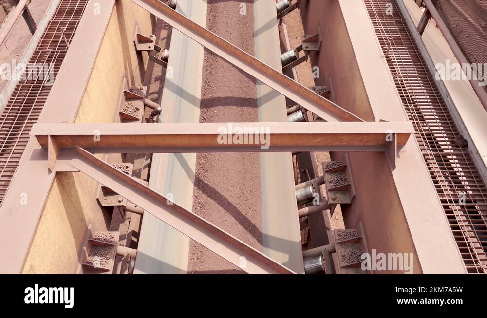 Iron Ore Pellet Carried By Industrial Conveyor Belt System With Pile Of ...