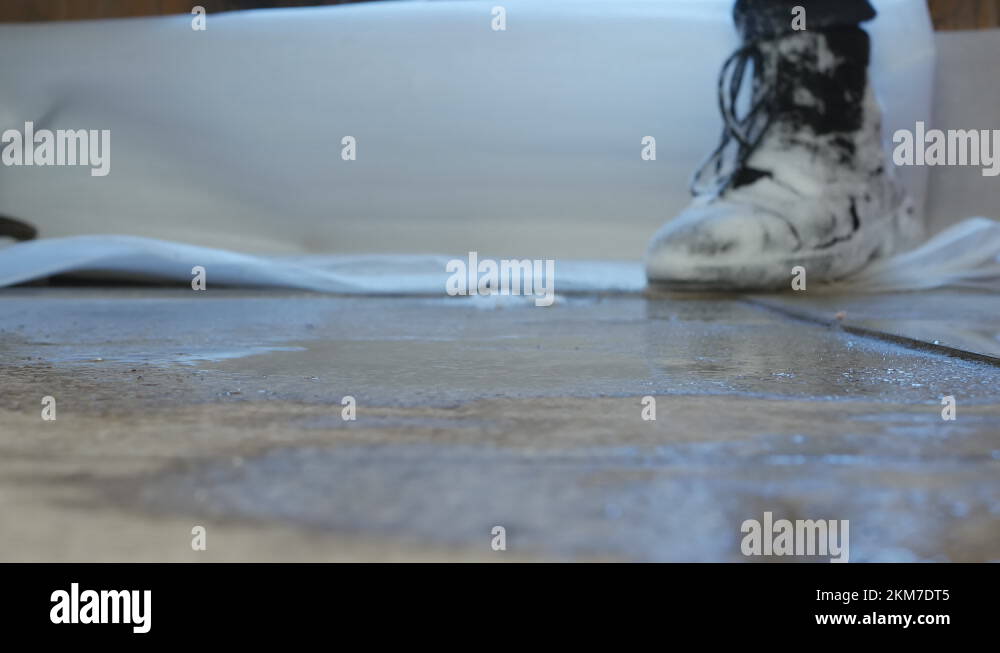 male adult feet in winter shoes shake off snow from boots stomping on ...