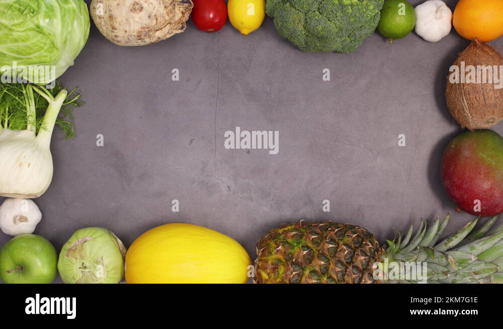 Creative frame with copy space made of fruits and vegetables move. Stop ...
