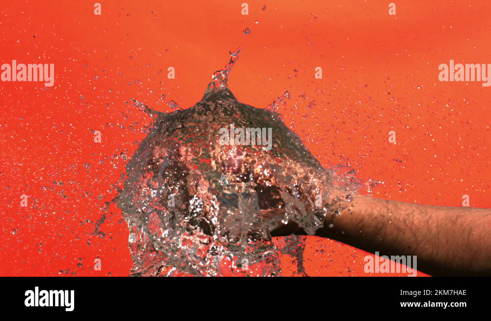 Explosion of Blue Water Balloon in a Palm on a Terracotta Background ...