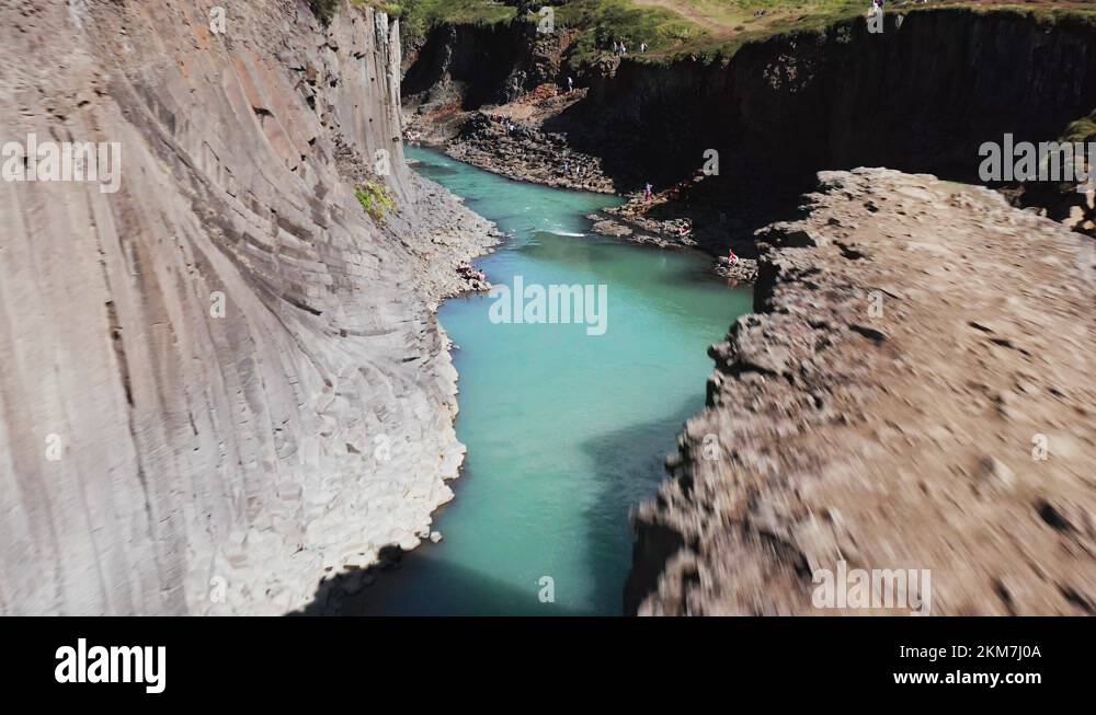 Aerial through Studlagil ravine with basalt columns in Iceland, tourist ...