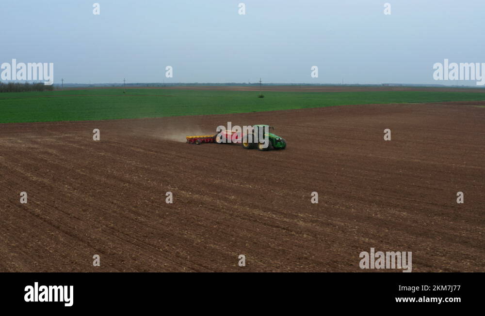 Farming Tractor Plowing Rows of Farmfield In Slavonia Region In Croatia ...
