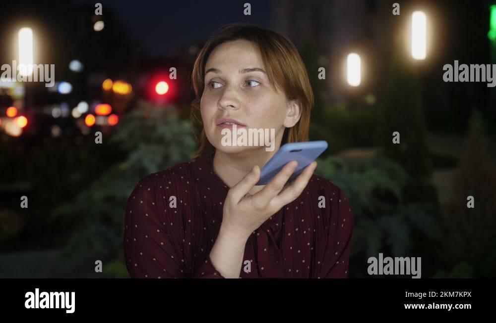 Woman makes short phone call by speakerphone, using telephone Stock ...