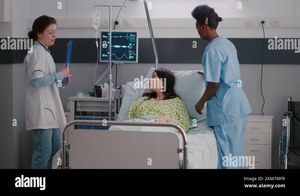 Medical practitioner doctor checking sick woman monitoring disease ...