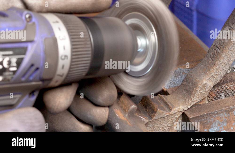 Skilled Mechanic Removing Rust Of A Brake Caliper Mount Of A Car's ...