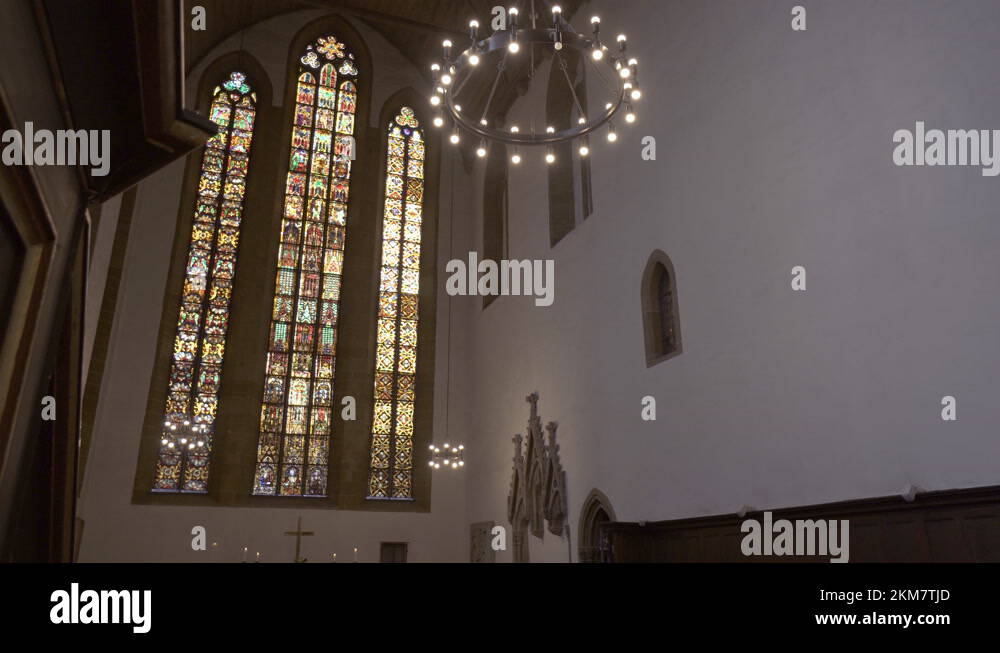 Panning Reveal Past A Statue To Reveal A Wall Of Soaring Stained Glass ...