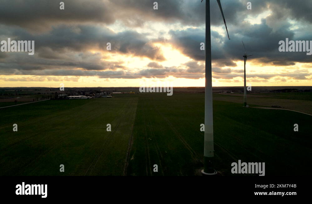Lift up reveal of giant wind turbines lining the beautiful countryside ...