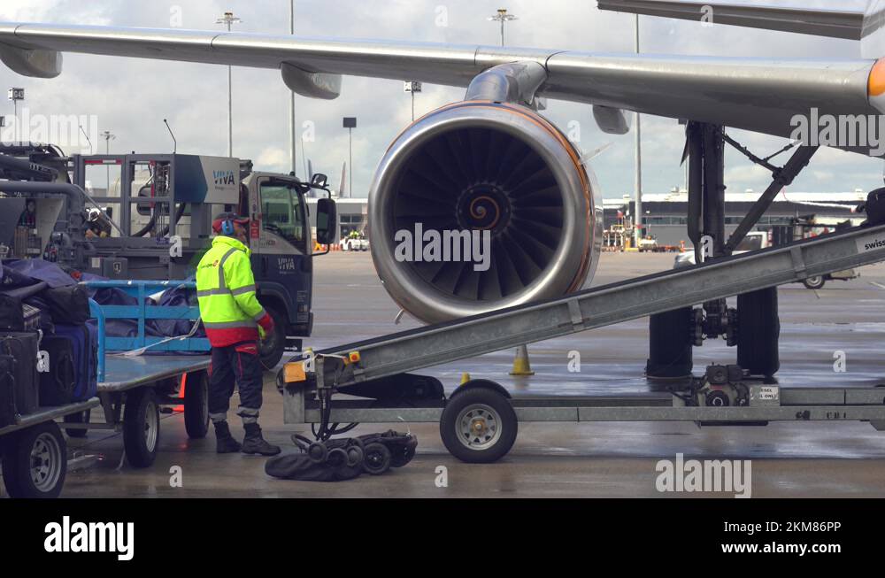 Footage of airport baggage handler ramp agent loading the baggages ...