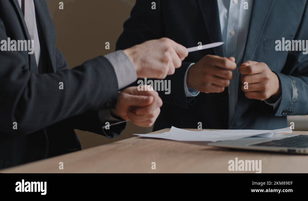 Close-up male hands two unrecognizable multiracial business men in ...