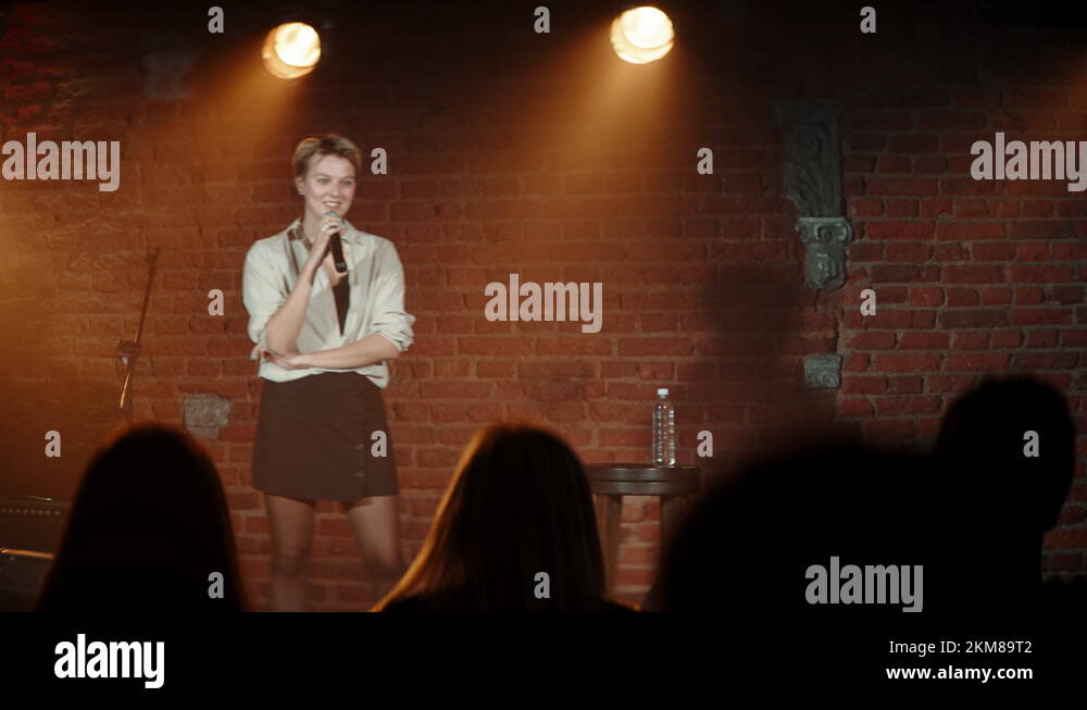 MED Caucasian female comedian performing her stand-up monologue on a ...