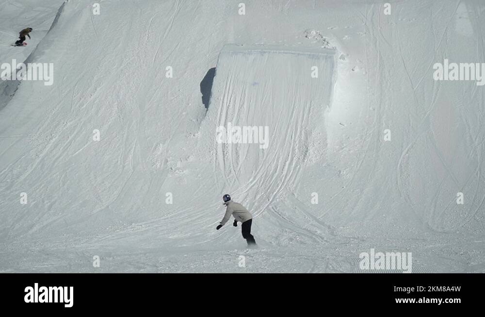 Snowboard professional rider jumping on kicker making flip and spin in ...