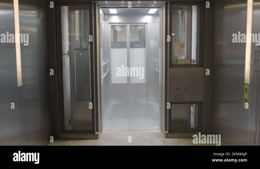 Moving Away From A Glass Elevator In An Industrial Building As The ...