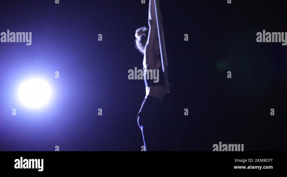 Woman circus artist make a show on stage hanging on a ring Stock Video ...