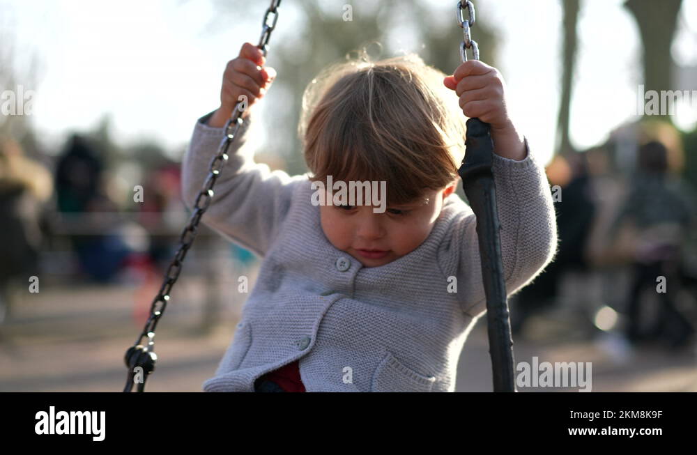 Child turning and twisting at playground swing Stock Video Footage - Alamy