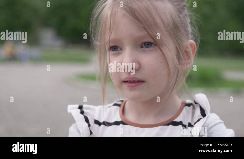 Close-up cute little girl talking in the street Stock Video Footage - Alamy