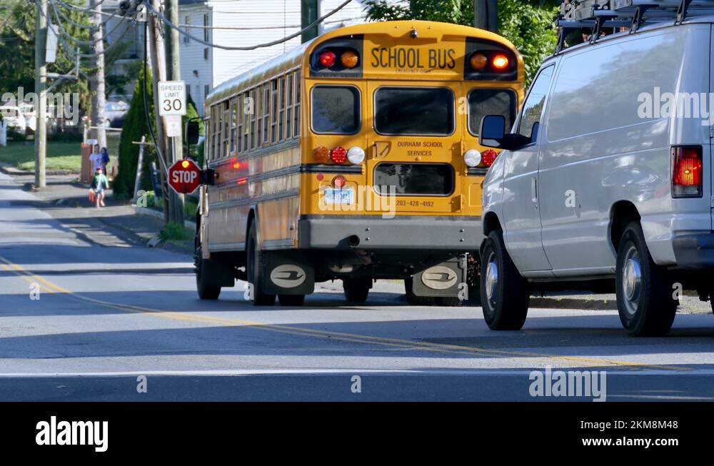 American school bus on street and woman walking with kids to bus Stock ...