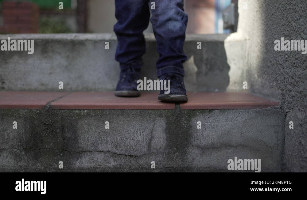 Toddler boy stepping down staircases outside. Child feet step Stock ...