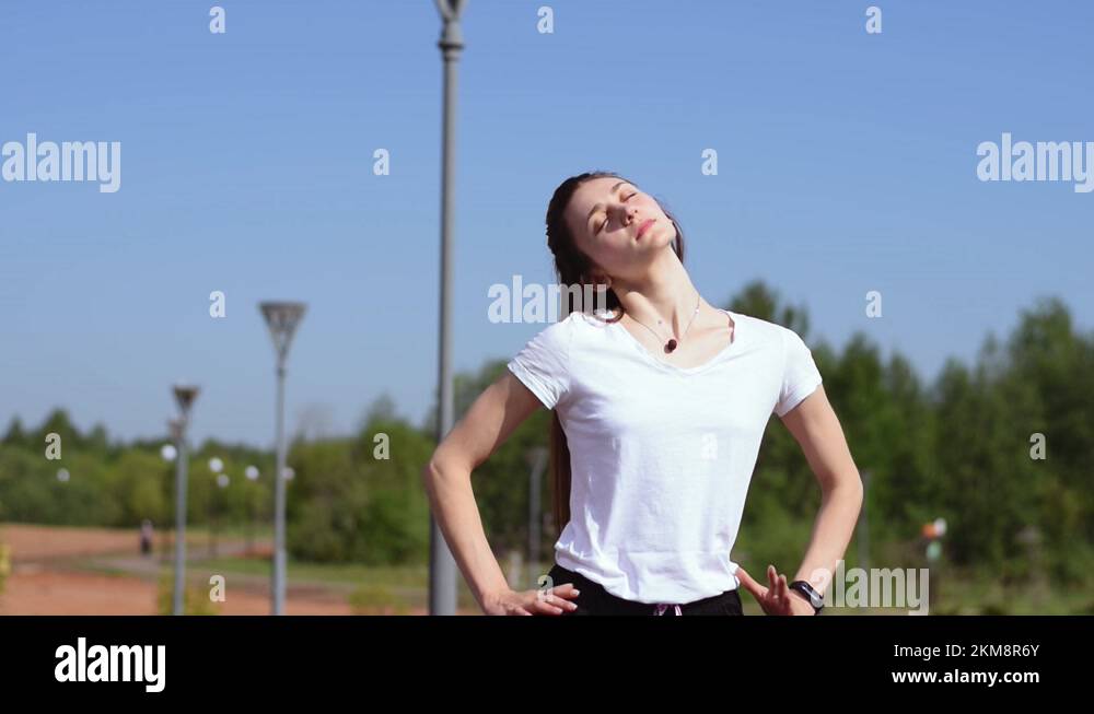 Girl warms up the muscles of the neck, shoulders before training Stock ...