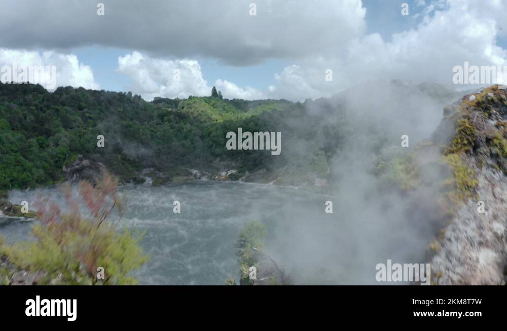 Moving past rock vents with steam to reveal Frying Pan Lake hot spring ...