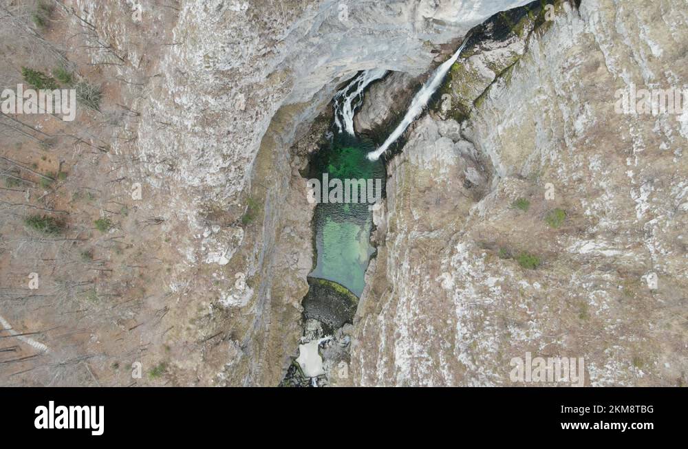 Bird's-eye view of Savica waterfall in Slovenia. Overhanging rock walls ...