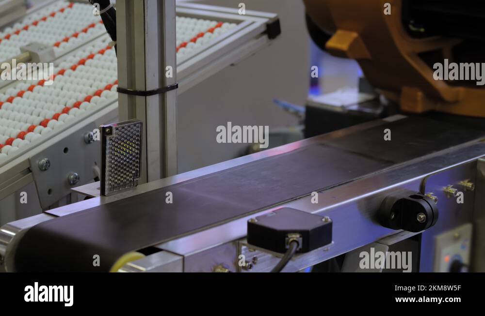 Pick and place robotic arm manipulator moving plastic detail on ...