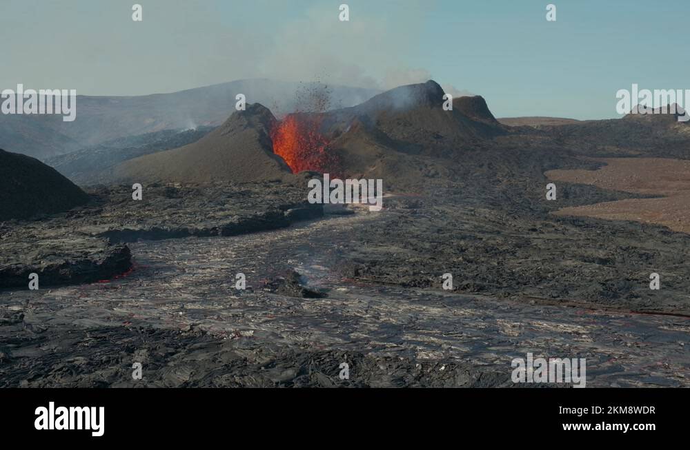 Volcano erupting magma and lava river in daylight, Iceland. Static view ...