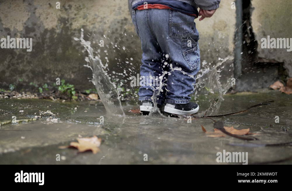 Kid child jumping puddle water splash Stock Videos & Footage - HD and ...