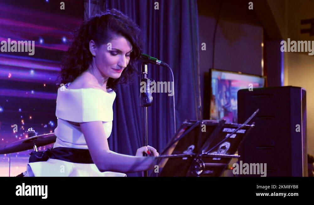 Singing woman with a microphone. Karaoke bar. professional singer Girl ...