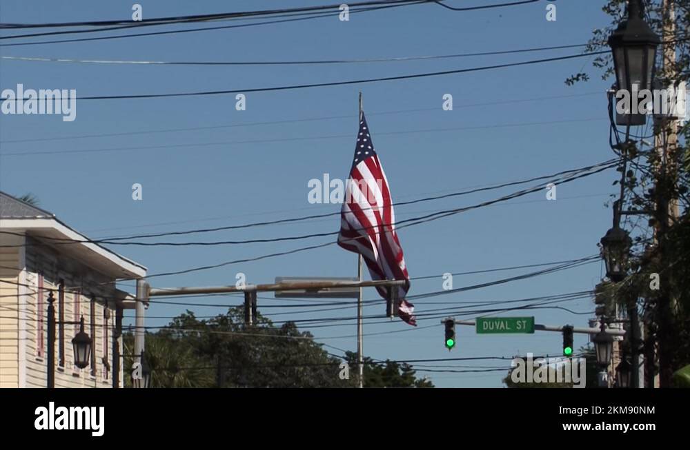 US flag in the wind on famous Duval Street in Key West, Florida, USA ...