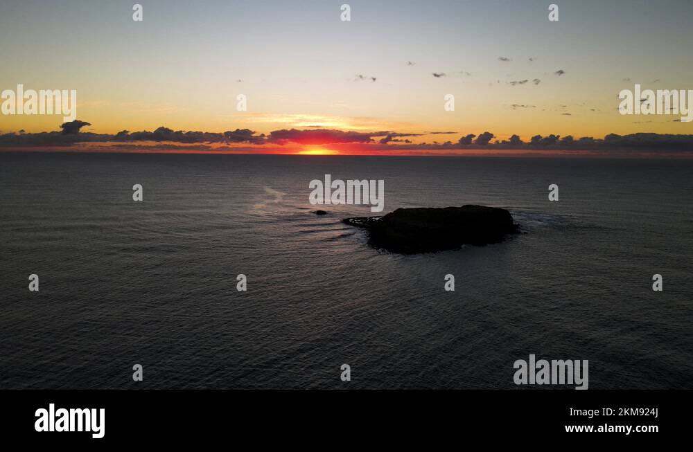 A Marine Park Island rising above the ocean contrasted against an early ...