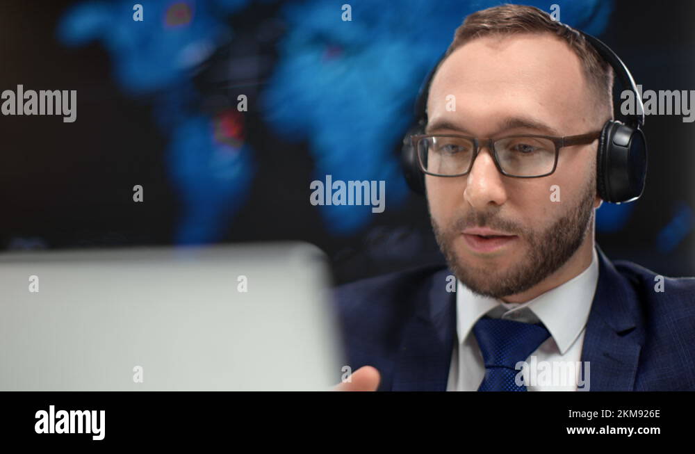 Closeup face handsome male boss in headset talking online video call ...