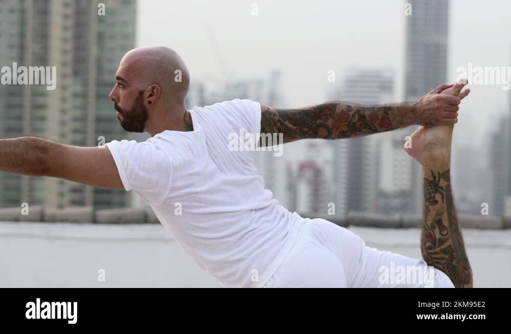 Man Dressed In White-T-shirt Standing One Foot At The Same Time Stock ...