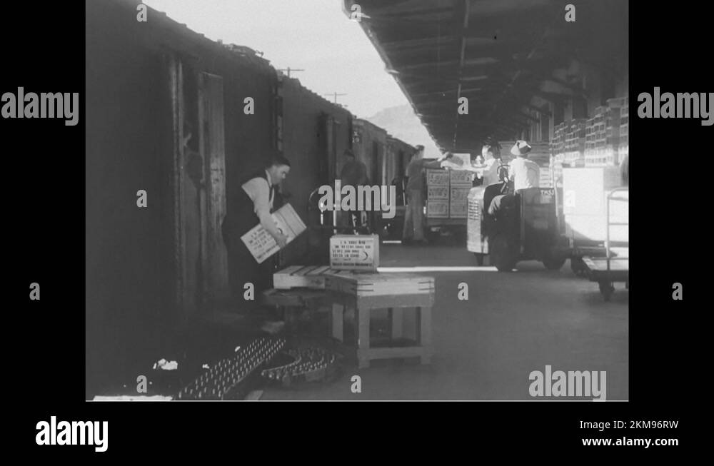 1940s: Men unload boxes from train. Men depart train car. Men walk away ...
