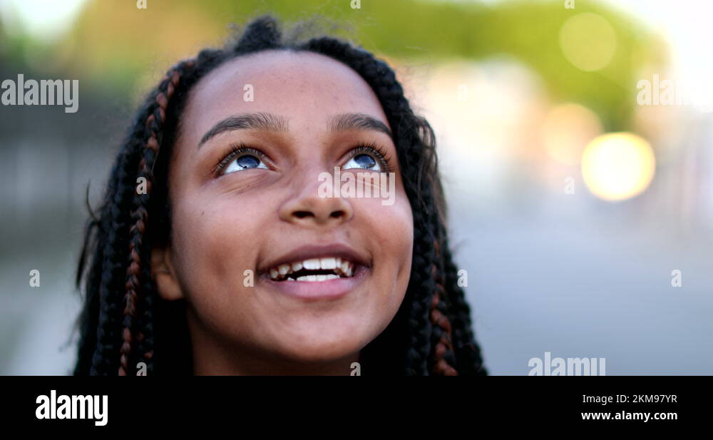 Happy black preteen girl child face smiling and looking up to sky Stock ...
