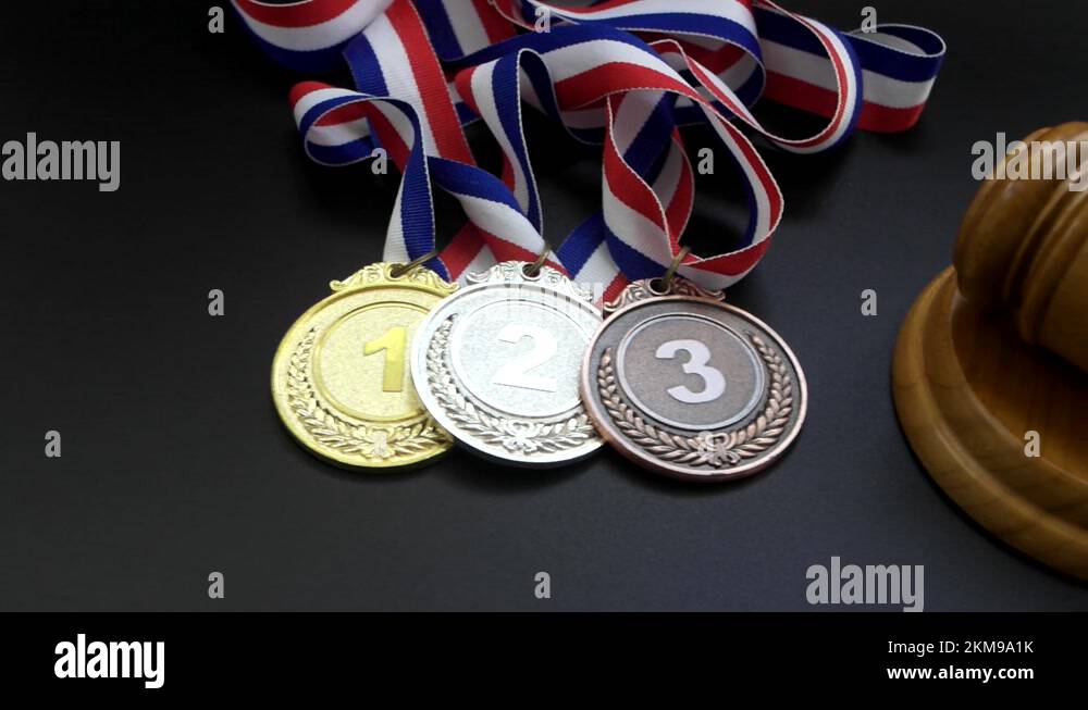 Gold medal, silver medal, bronze medal and wooden judge gavel Stock ...