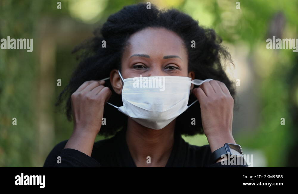 Black woman removing face mask feeling relief. African woman taking off ...