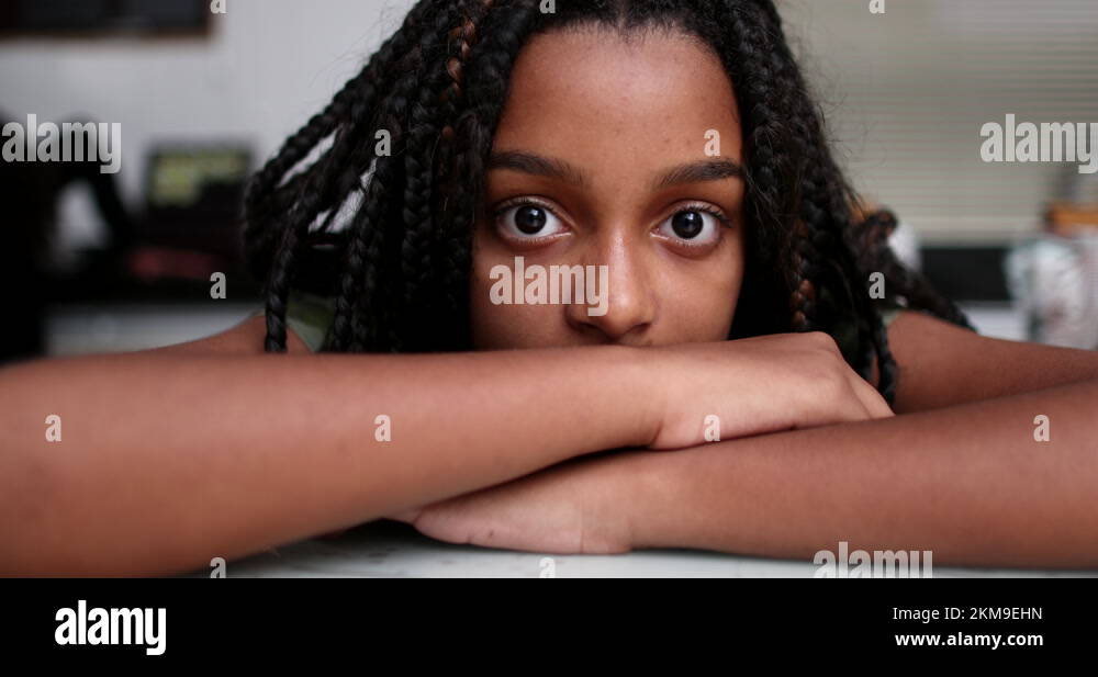 Black preteen girl eyes staring at camera. Adolescent teen face close ...