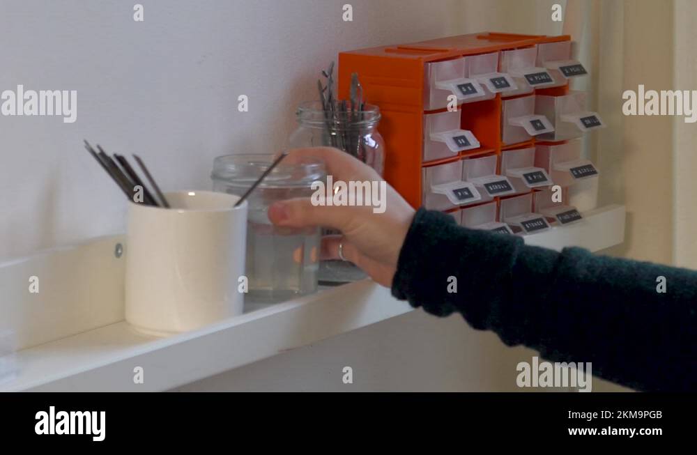 Product designer placing her tools back on the shelf Stock Video ...