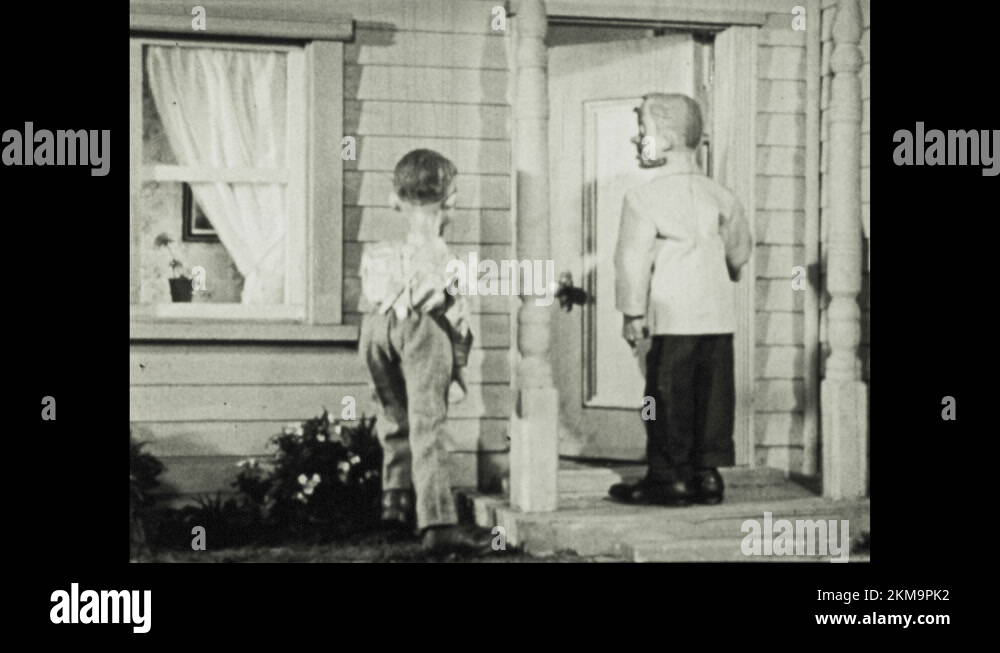 1940s: Two men knock on door of house, woman looks out window at them ...